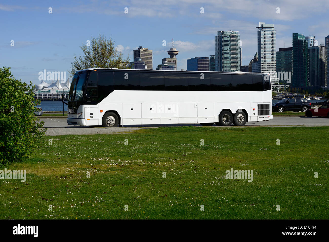 A tour bus is parked on a street at Stanley Park, Vancouver, British ...