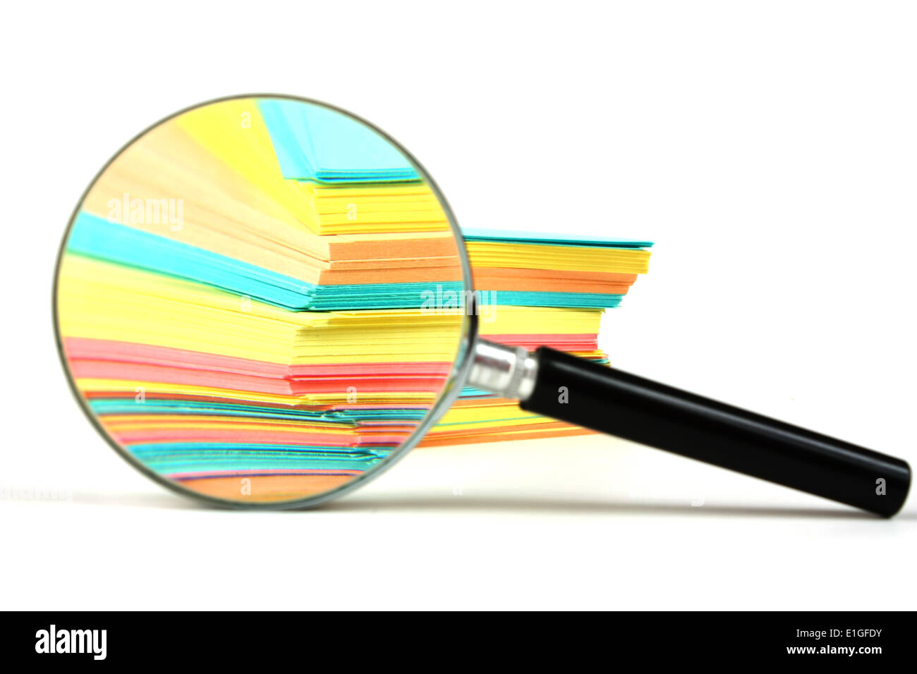 magnifying glass and a stack of paper for notes Stock Photo - Alamy