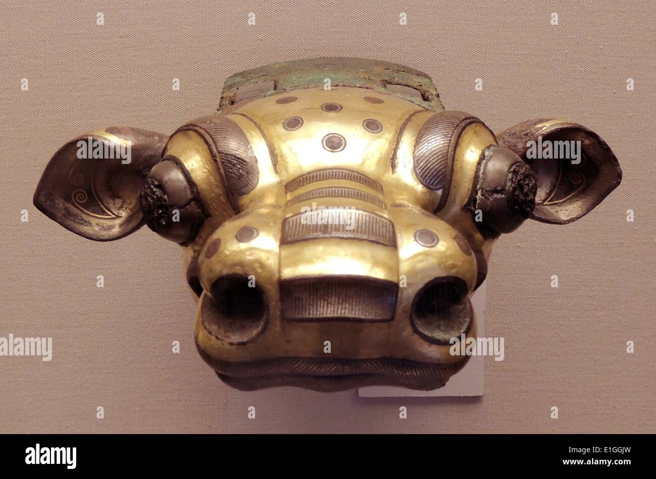 Bronze fitting in the shape of a bull's head inlaid with gold and ...