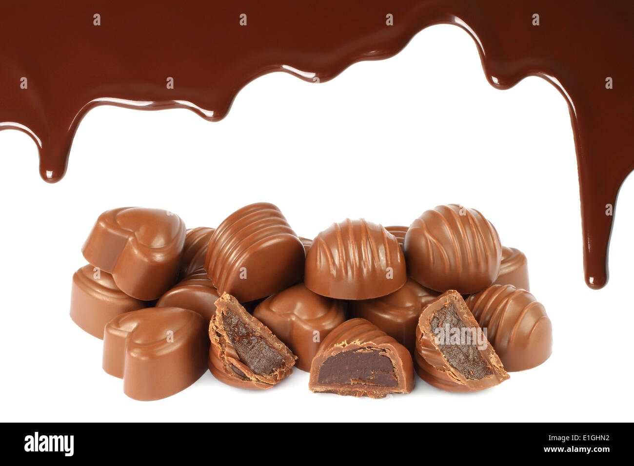 Melted chocolate dripping with candies on white background Stock Photo ...