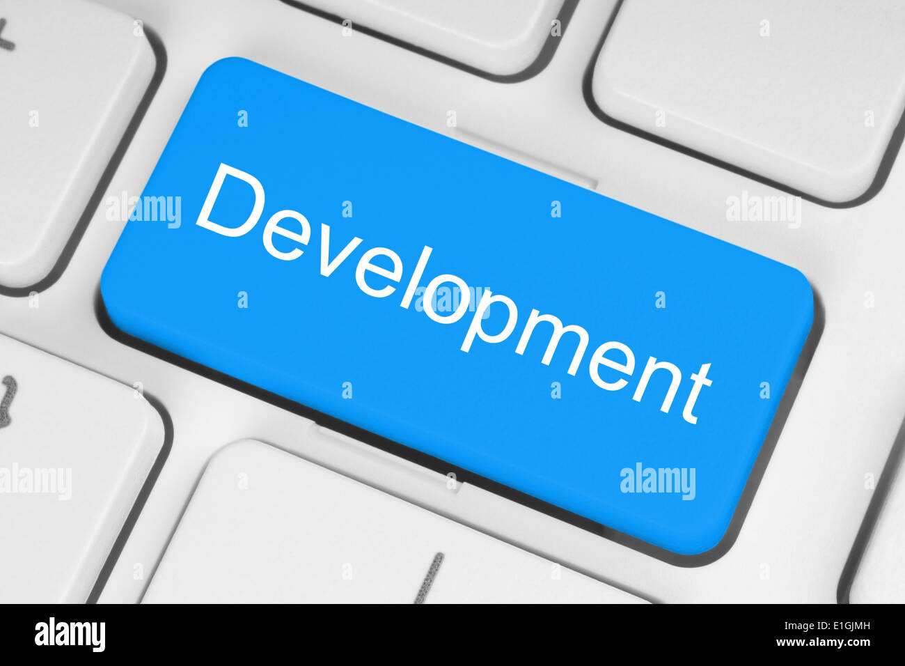 Blue development keyboard button Stock Photo - Alamy
