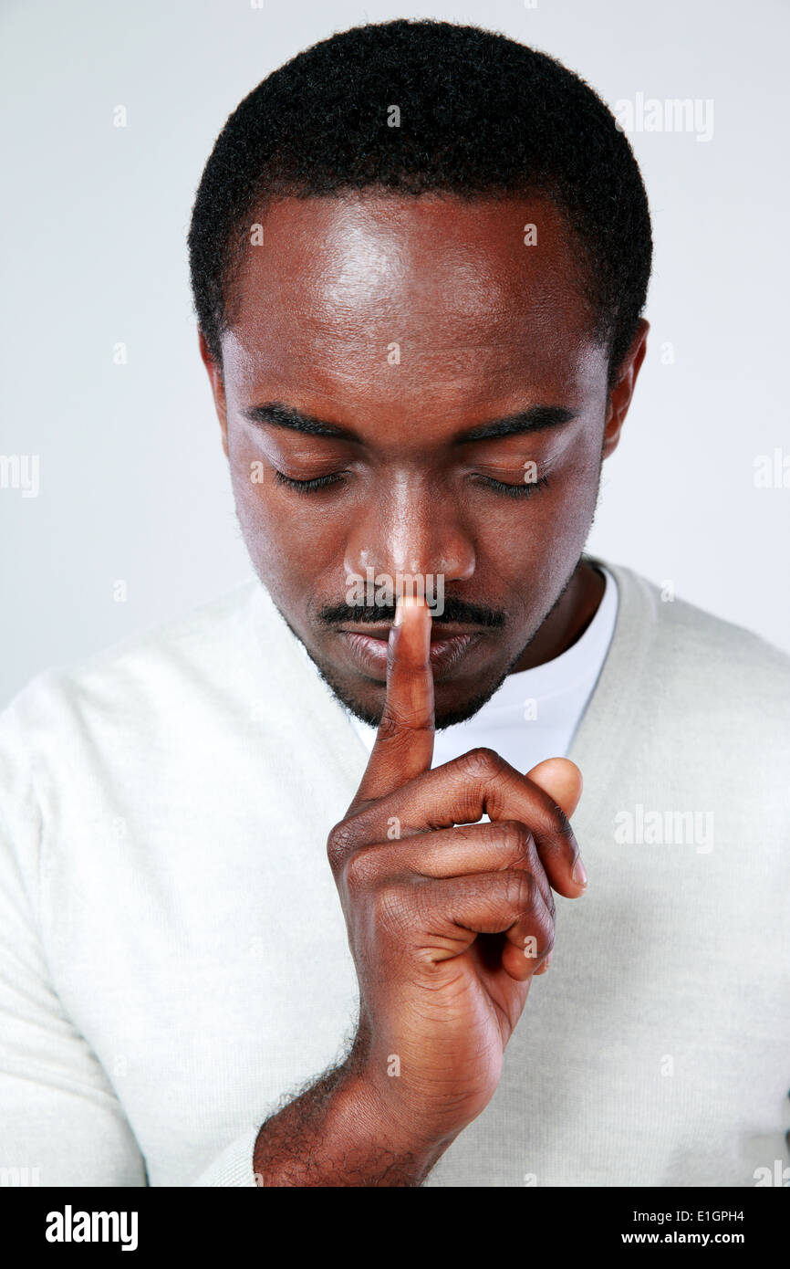 Face one finger over mouth hi-res stock photography and images - Alamy