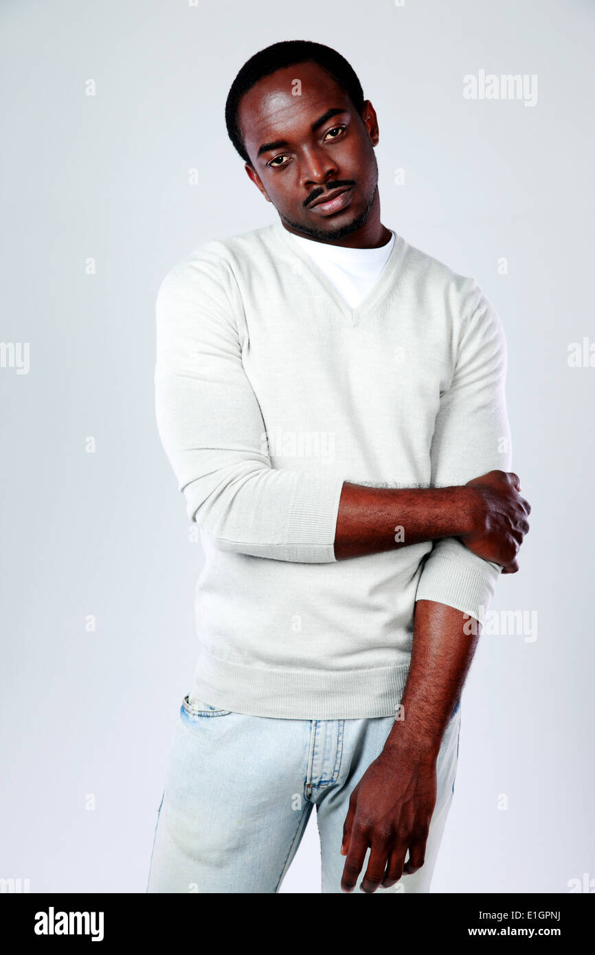 Portrait of a tired african man over gray background Stock Photo - Alamy