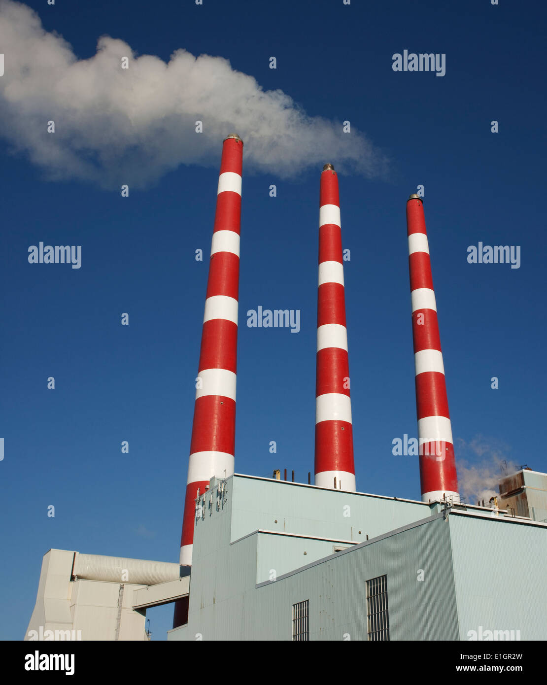 Industrial plant smoke stacks and blue sky Stock Photo - Alamy