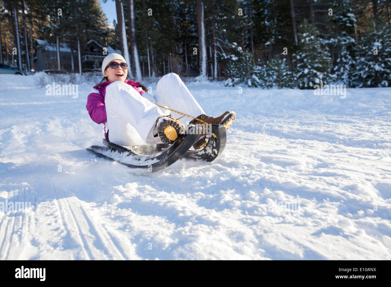 Woman sliding snow sled hi-res stock photography and images - Alamy