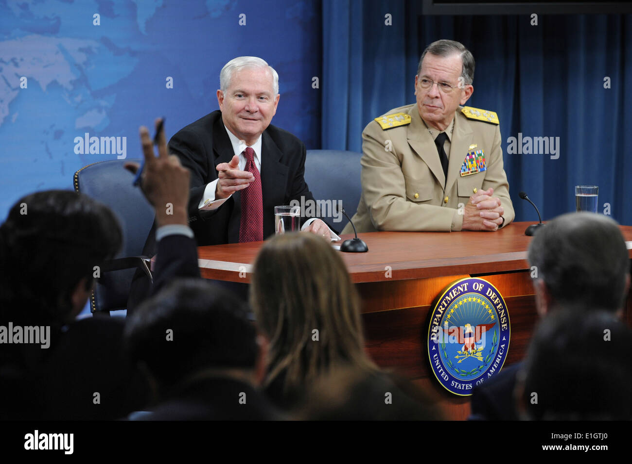 Secretary of Defense Robert M. Gates, left, calls on a reporter during ...