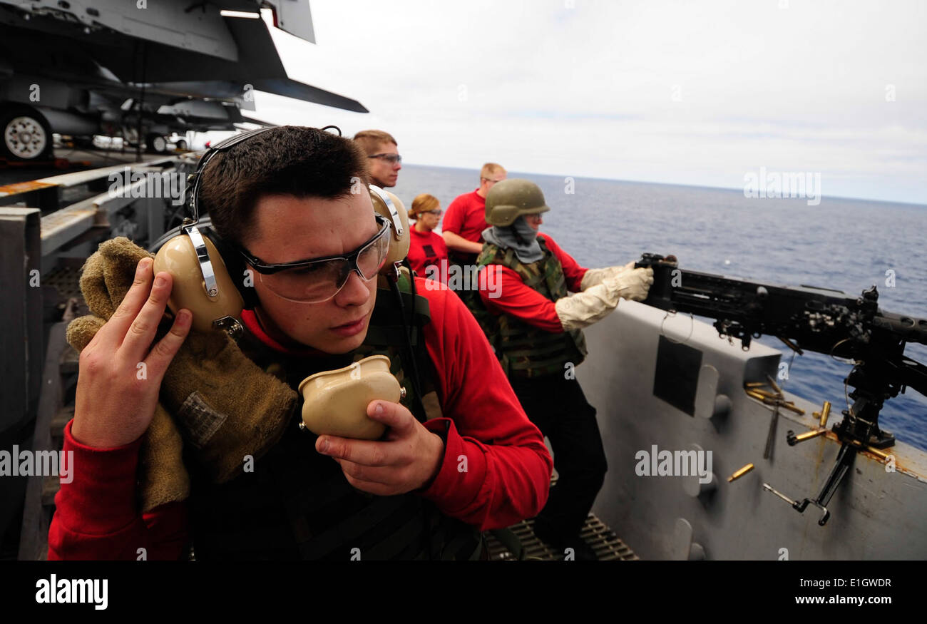 U.S. Navy Aviation Ordnanceman Airman Eric Hornbeck uses a sound ...