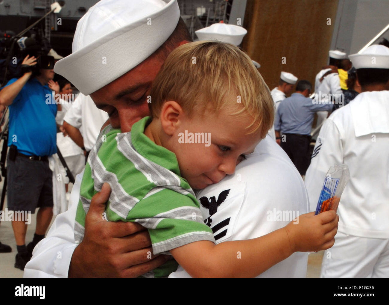 Petty Officer 2nd Class Tommy Neely holds his son after returning home ...