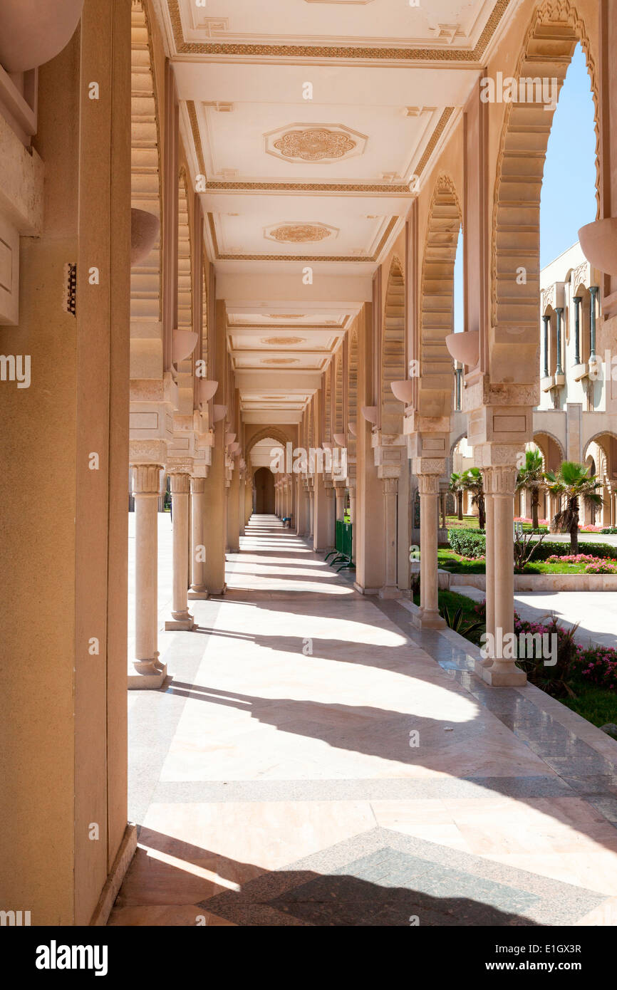Colonnaded walkway beside the Grand Mosque of Hassan II in Casablanca ...