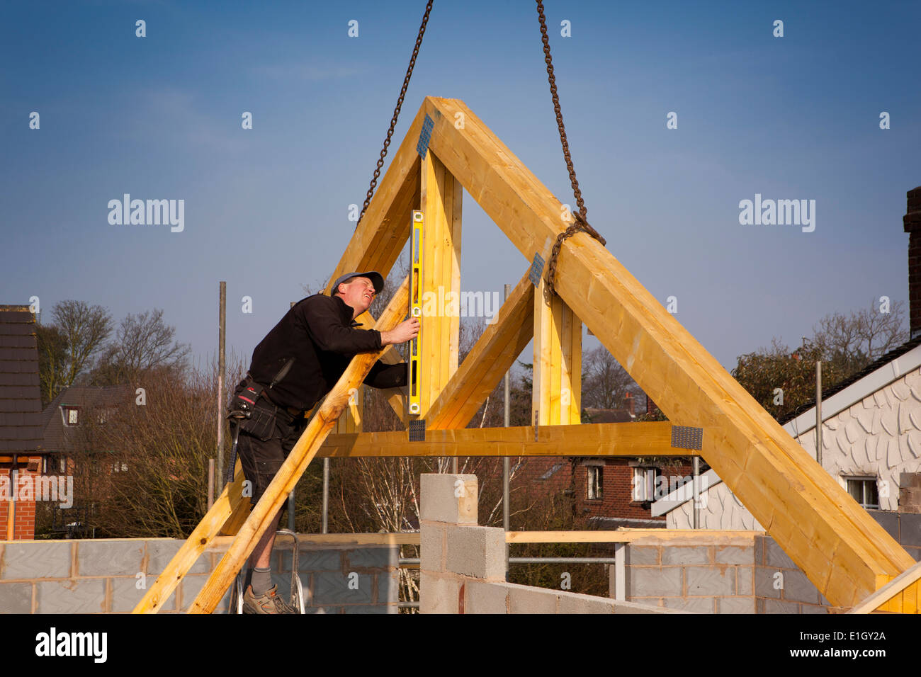 Crane lifting roof truss on High Resolution Stock Photography and ...
