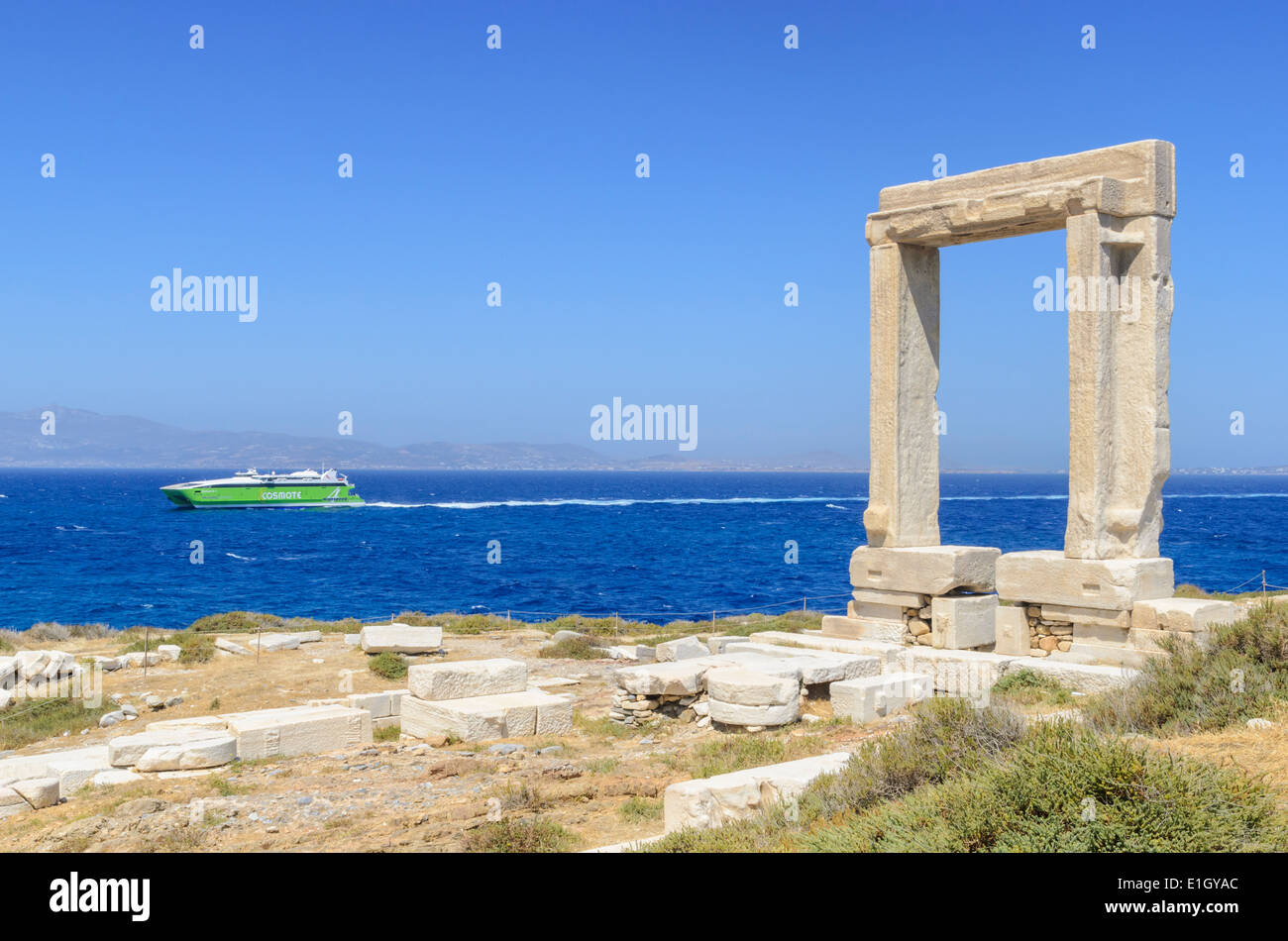 A Greek catamaran speeds past the Temple of Apollo Arch, Naxos Island ...
