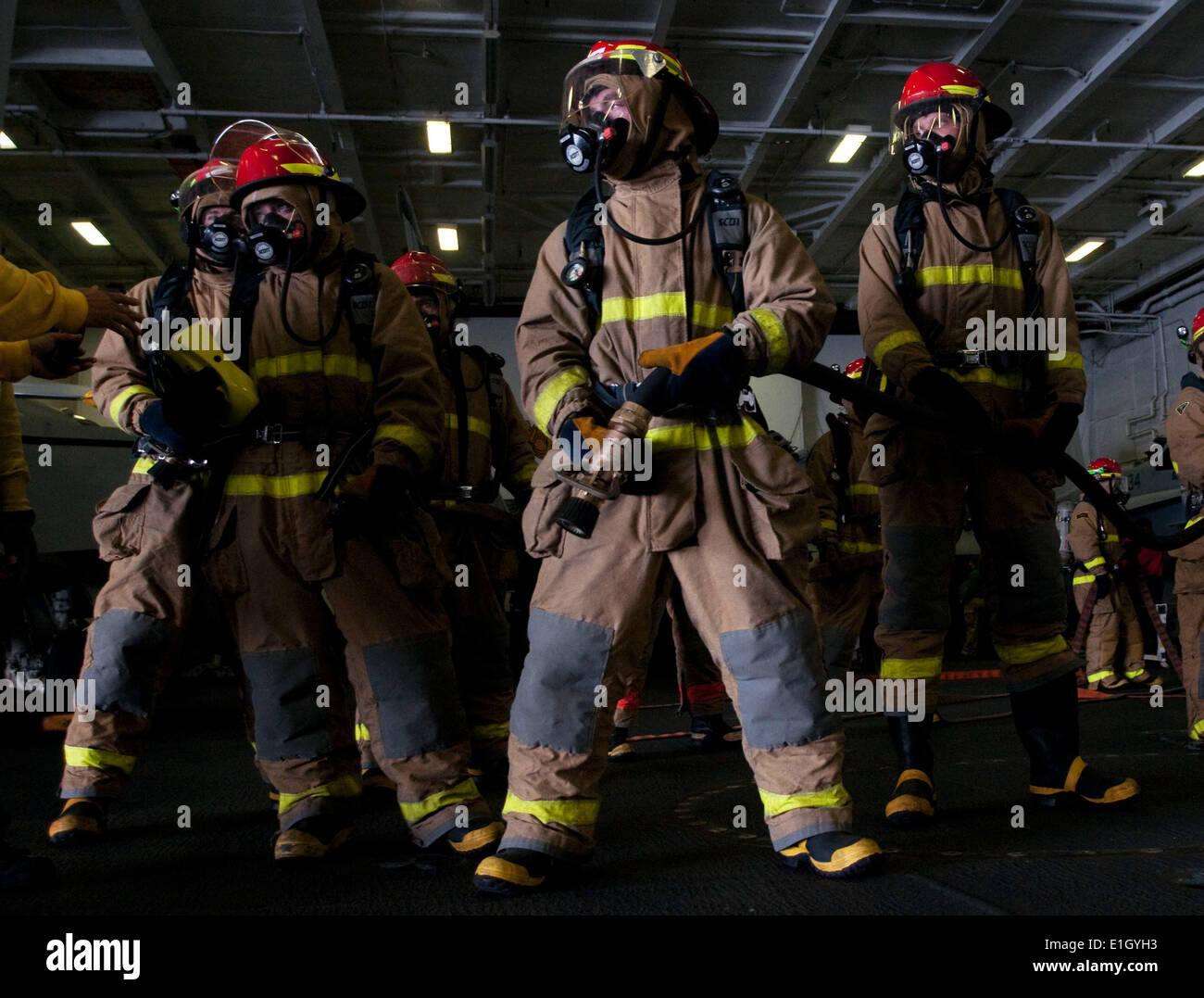 U.S. Navy damage controlmen receive instruction during a simulated ...
