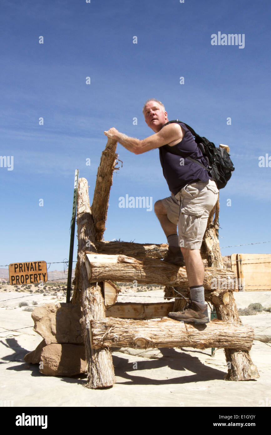 Man climb fence hi-res stock photography and images - Alamy