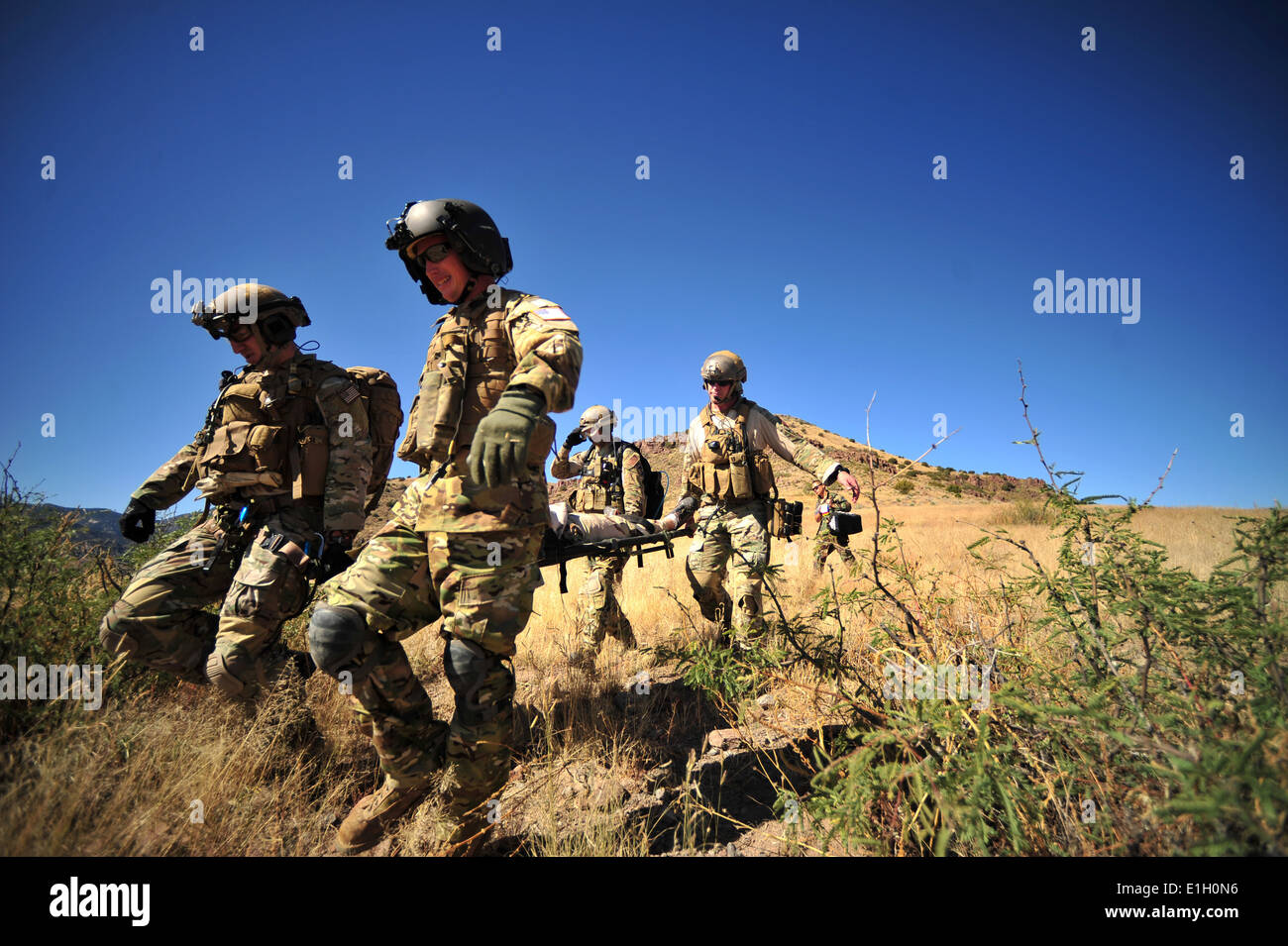 U.S. Air Force Combat Search and Rescue crew members carry litter Stock ...