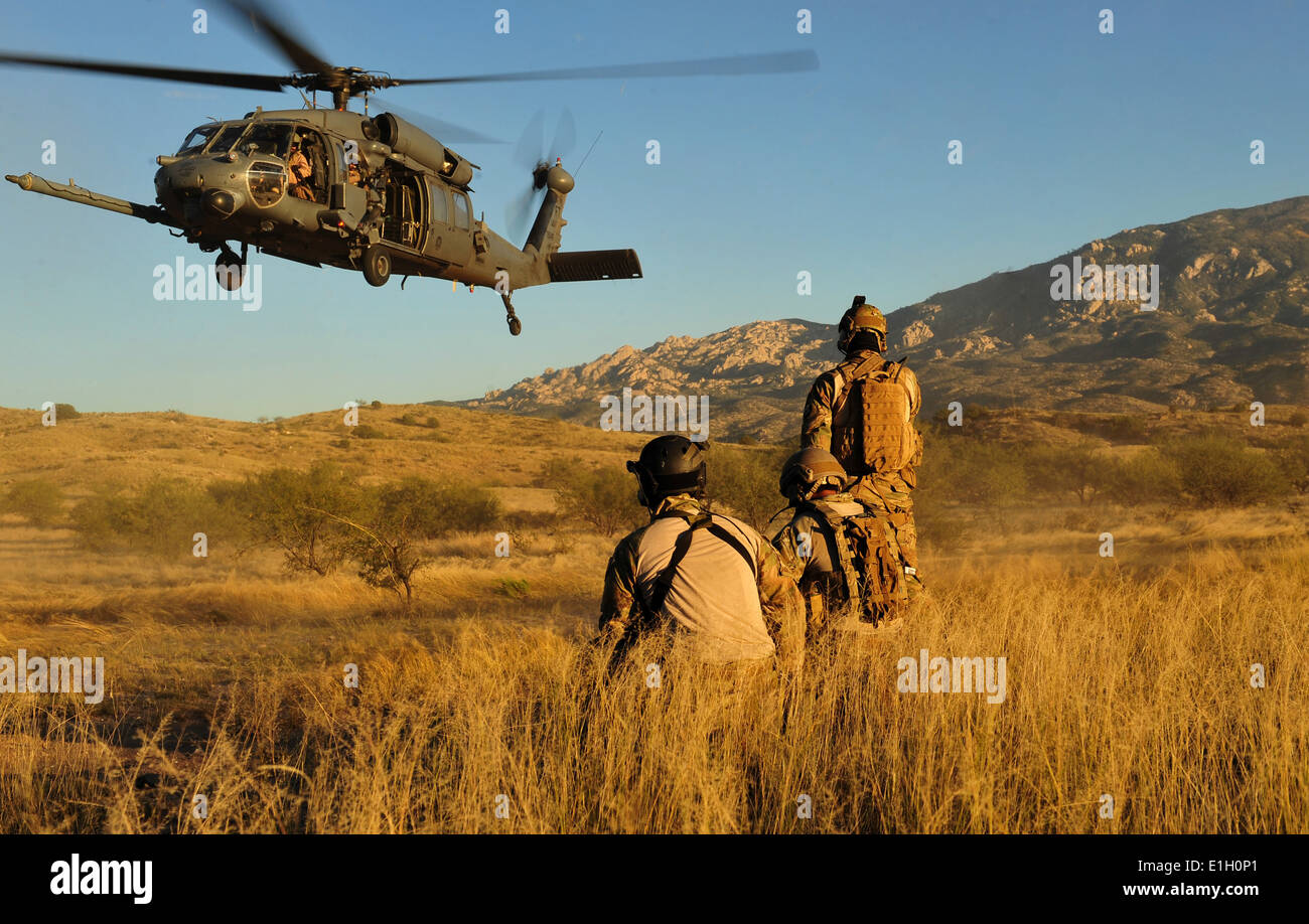 U.S. Air Force pararescuemen with the 58th Rescue Squadron signal in a ...