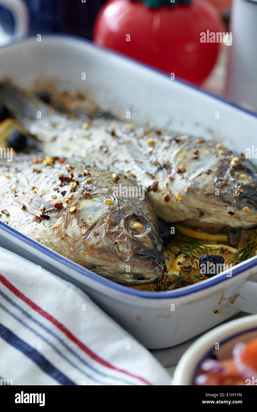 Tray of baked fresh fish Stock Photo - Alamy