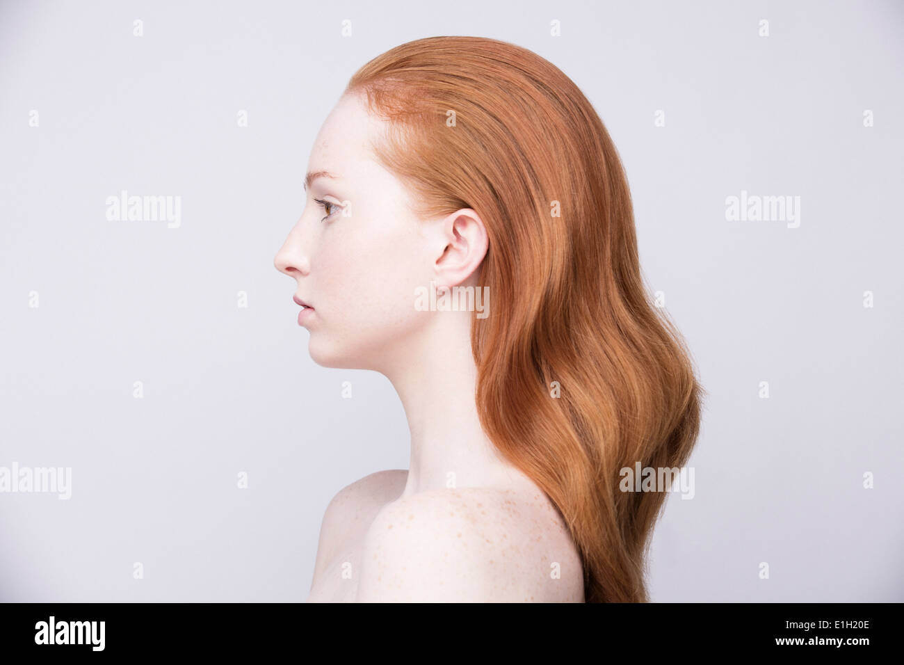 Portrait of young woman, side view, bare shoulders Stock Photo - Alamy