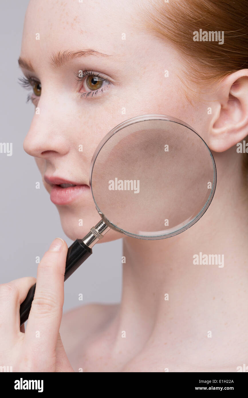 Magnifying glass on cheek hi-res stock photography and images - Alamy