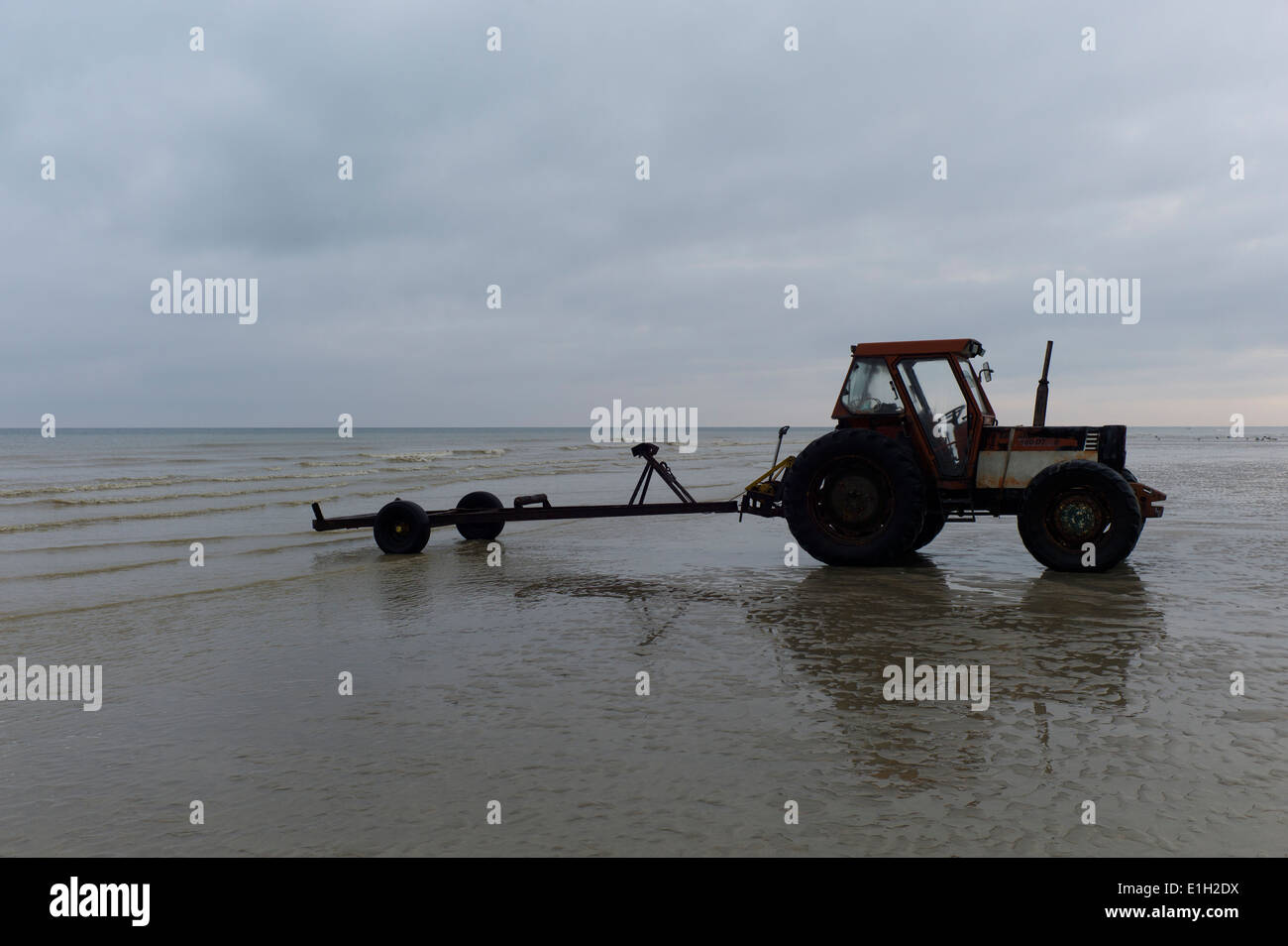 Fisherman's tractor on sandy beach, low tide, St Aubin-sur-mer ...