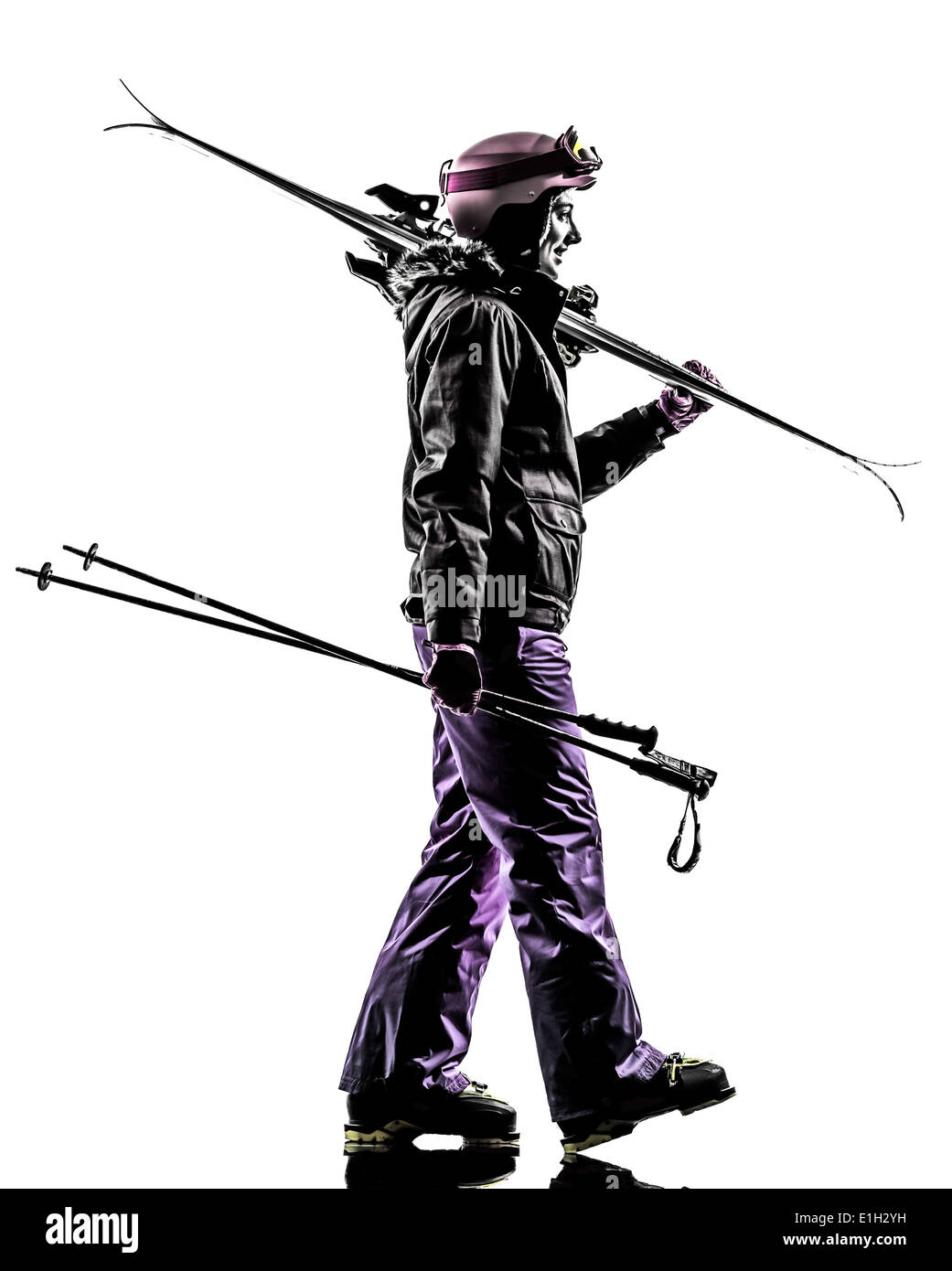 one woman skier walking side view in silhouette on white background ...