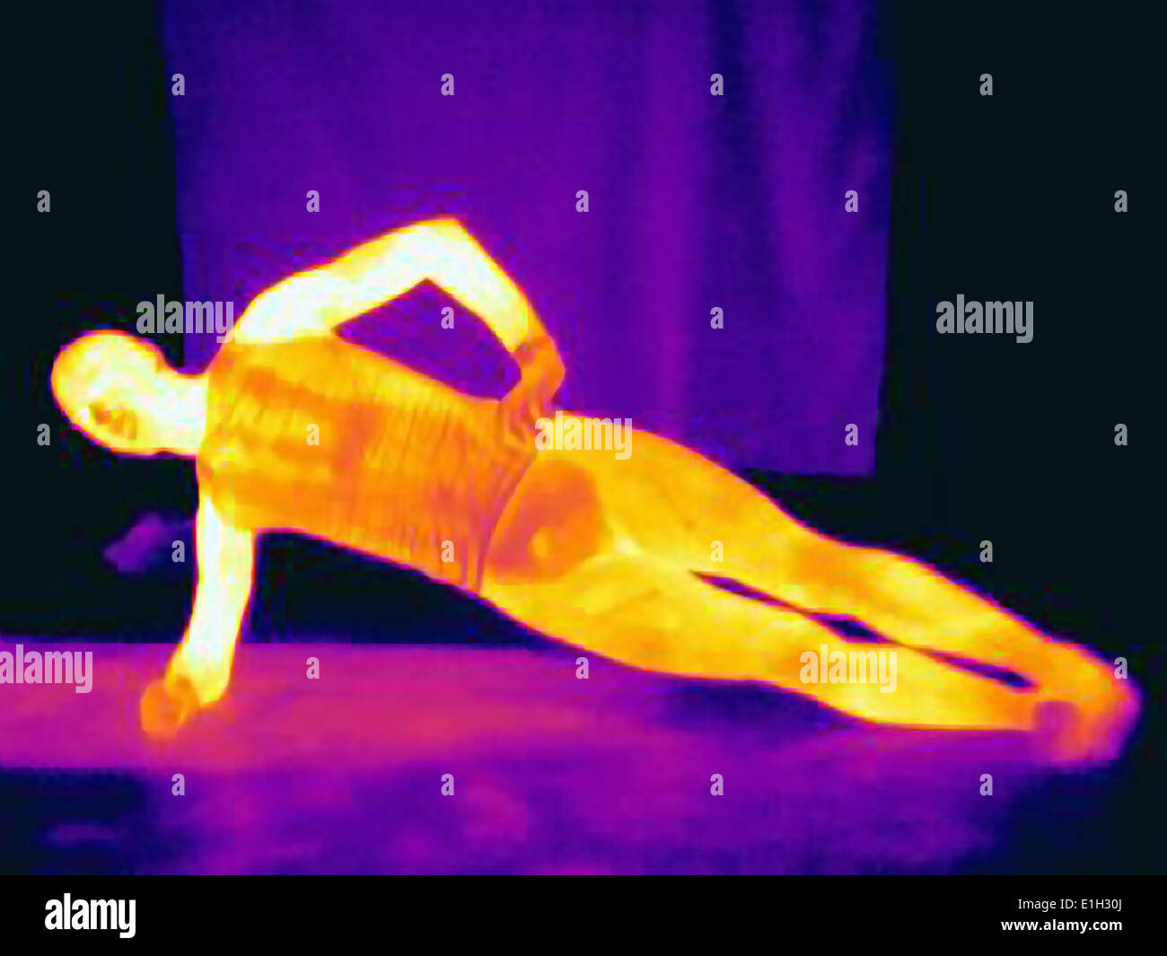 Thermal image of young male athlete doing one arm push ups. The image ...