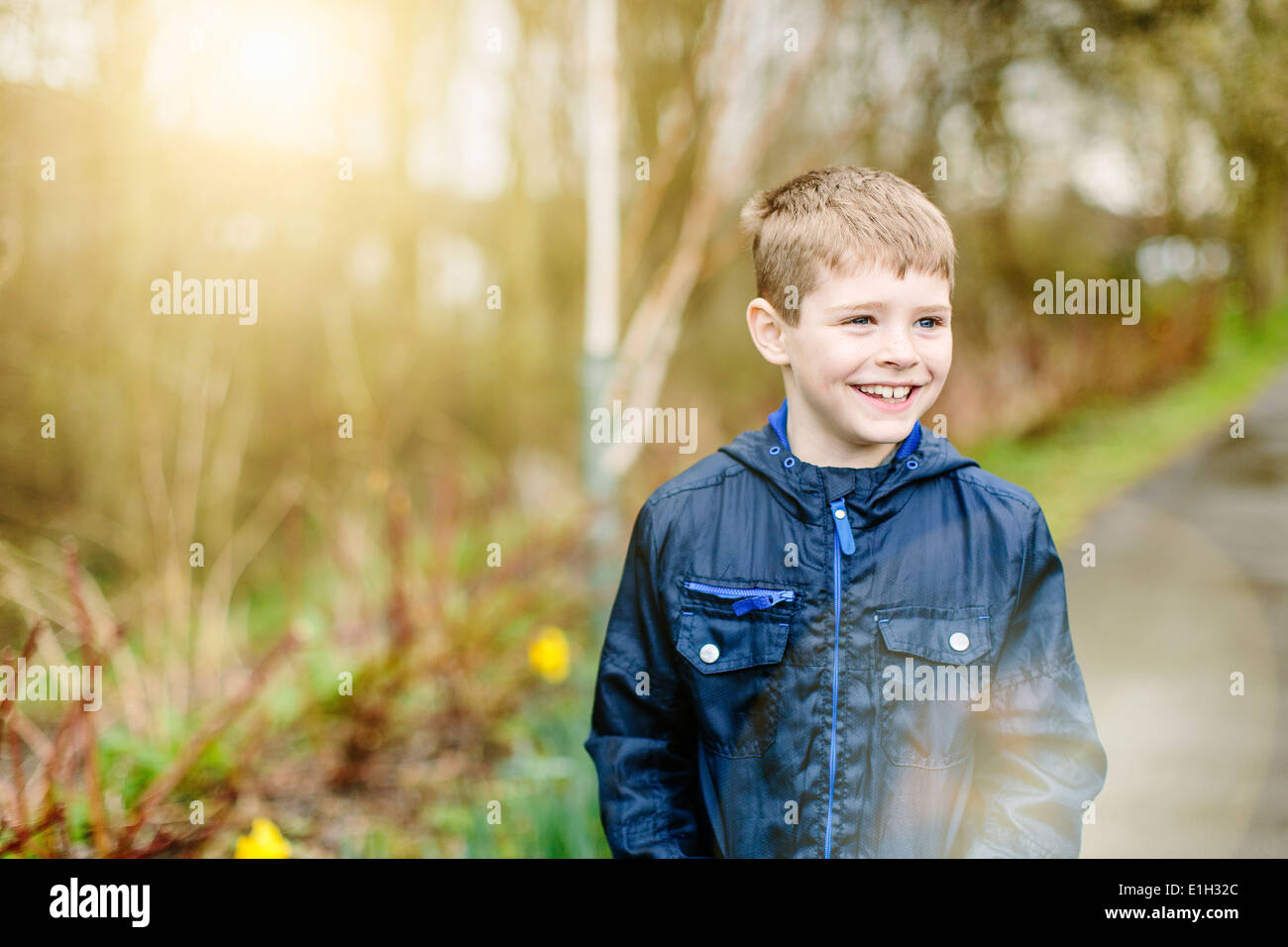 Boy standing outdoors Stock Photo - Alamy