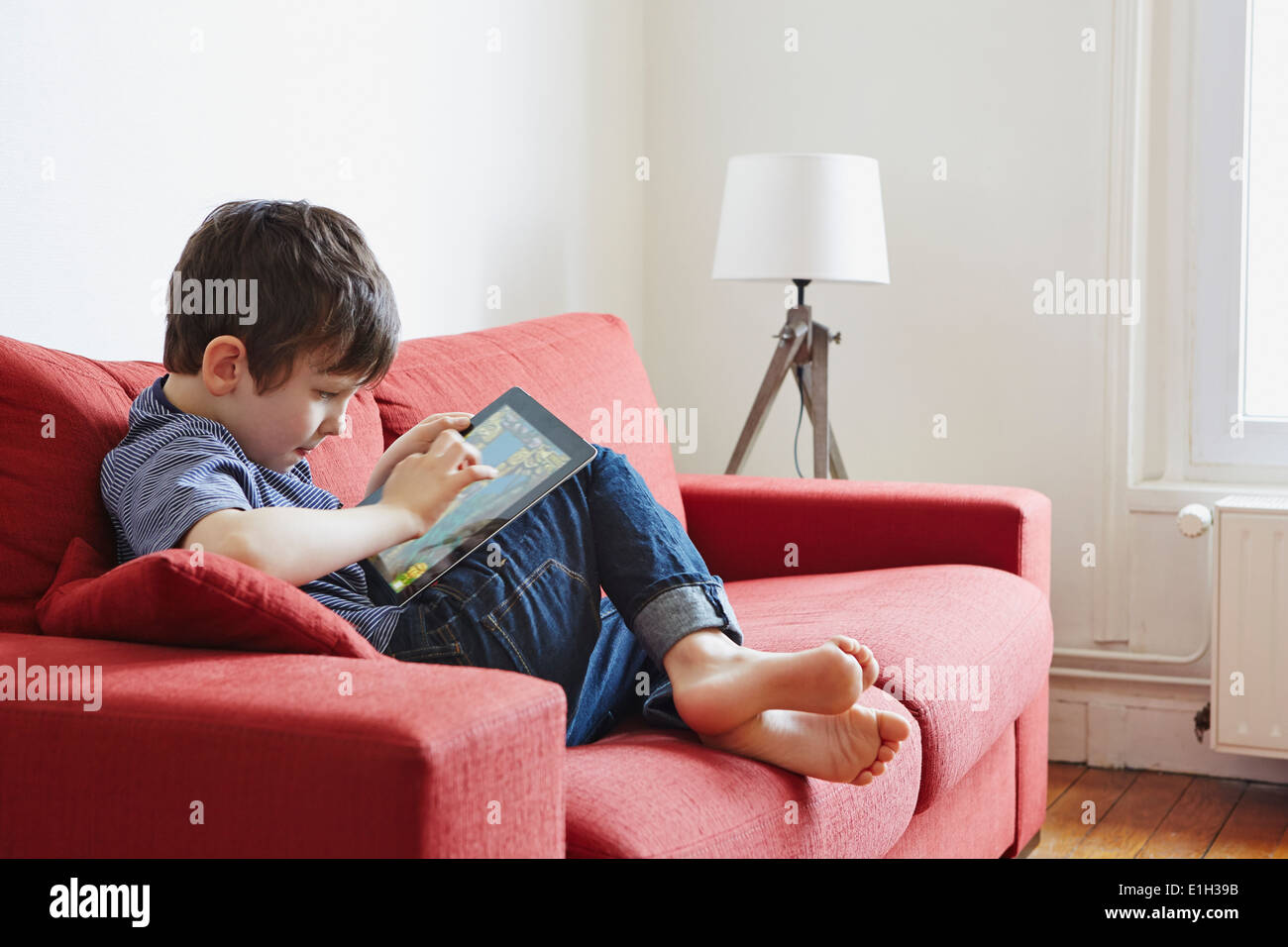 Boy using digital tablet Stock Photo - Alamy