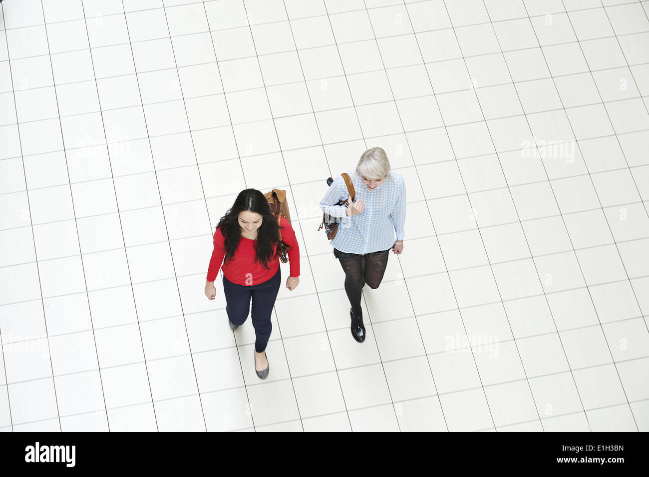 Two young women walking, high angle Stock Photo - Alamy