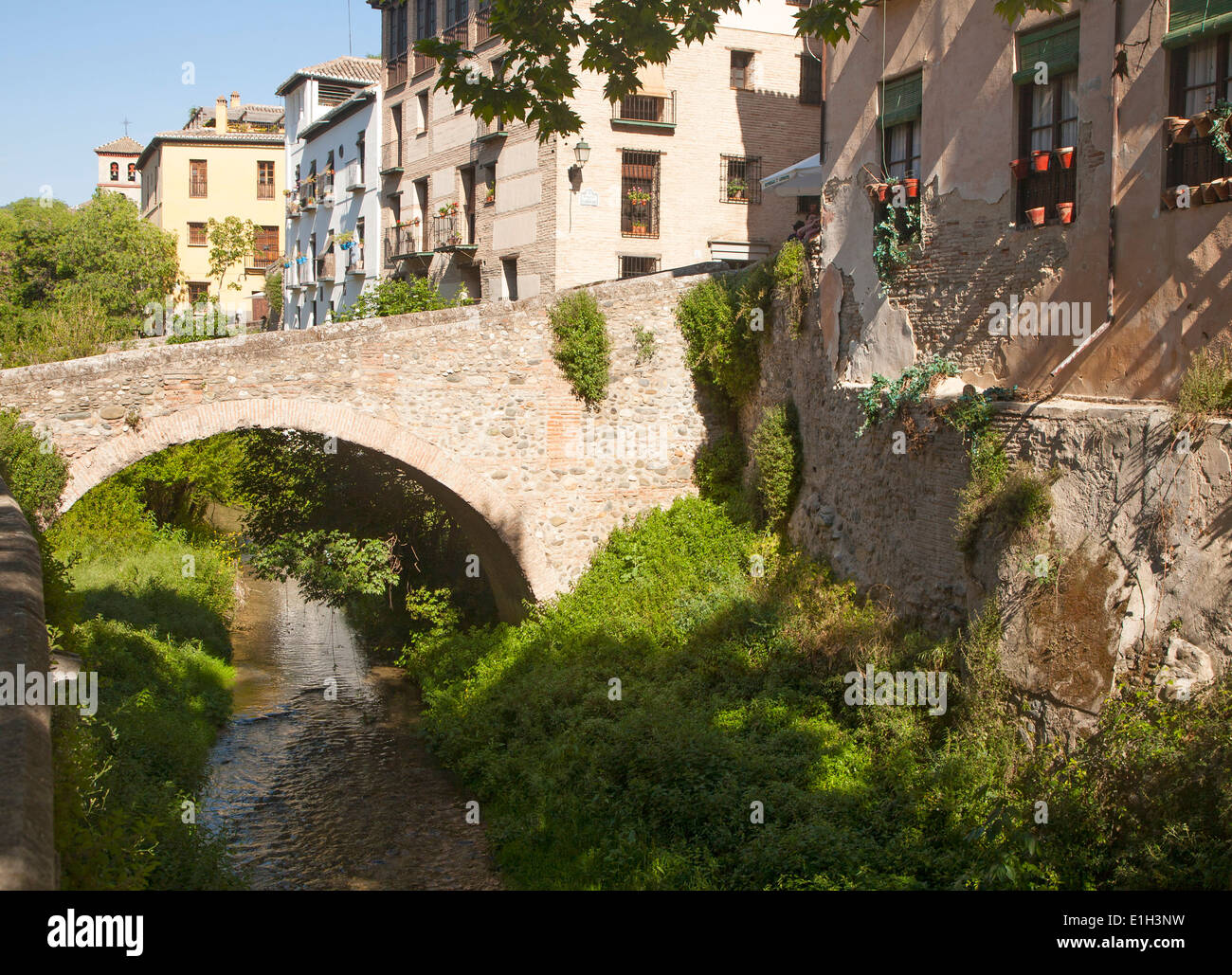 Historic stone bridge crossing the River Darro, Granada, Spain Stock ...