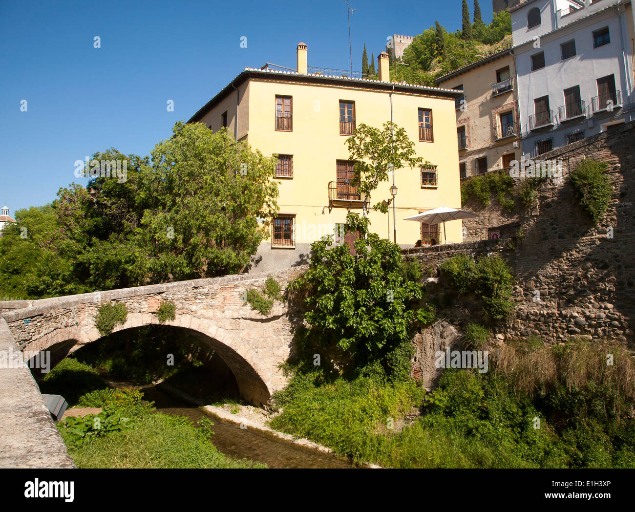 Historic stone bridge crossing the River Rio Darro, Granada, Spain ...