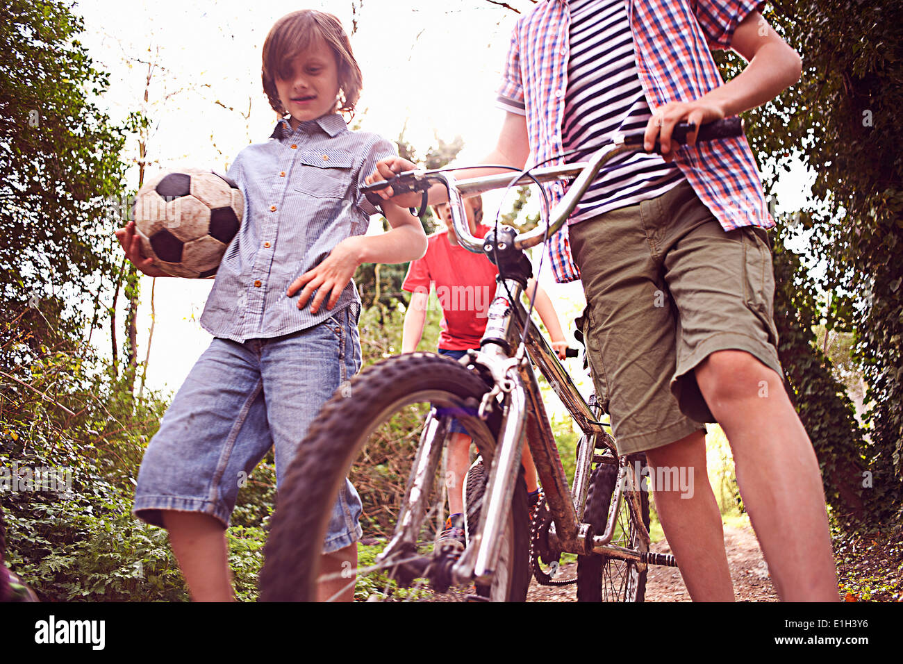 Boys with bikes and football Stock Photo - Alamy