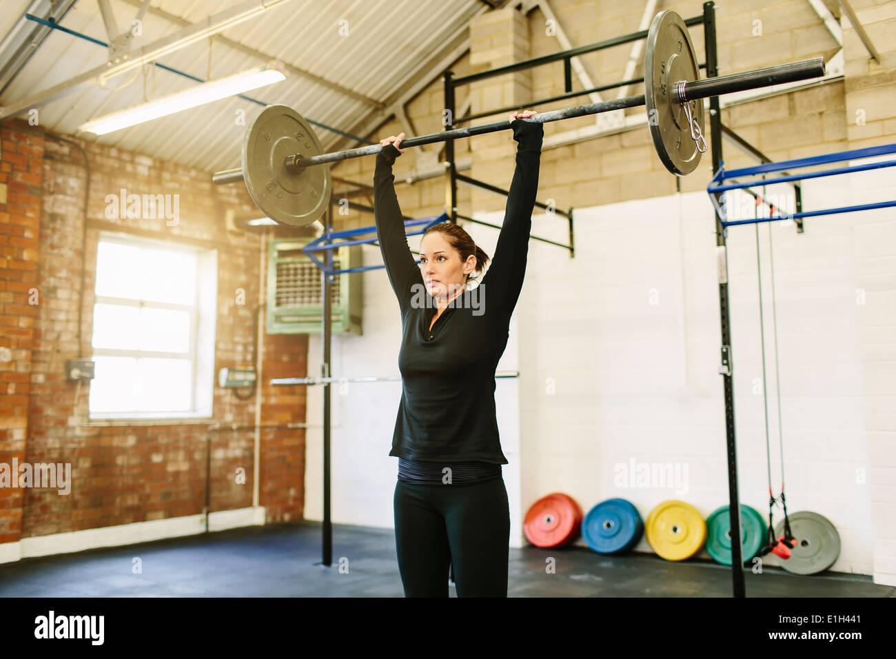 Woman lifting weights in gym hi-res stock photography and images - Alamy