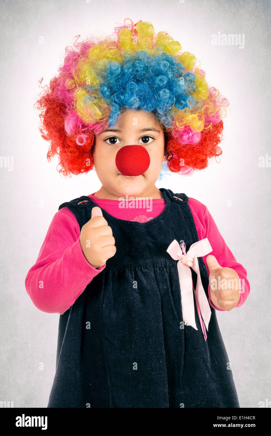 Little child with clown mask holding thumb up Stock Photo - Alamy