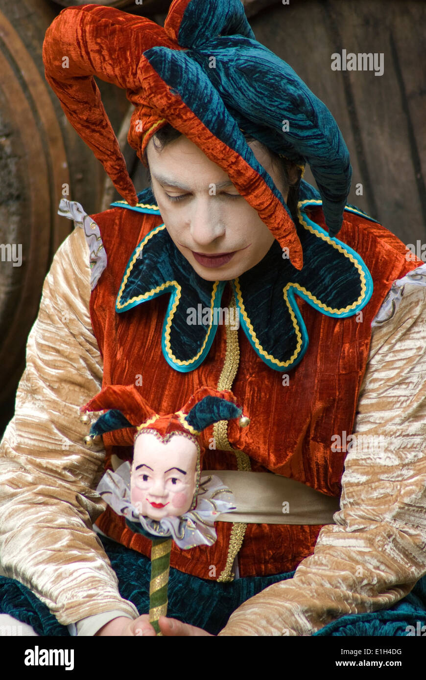 Sad jester sitting in front of barrels Stock Photo - Alamy