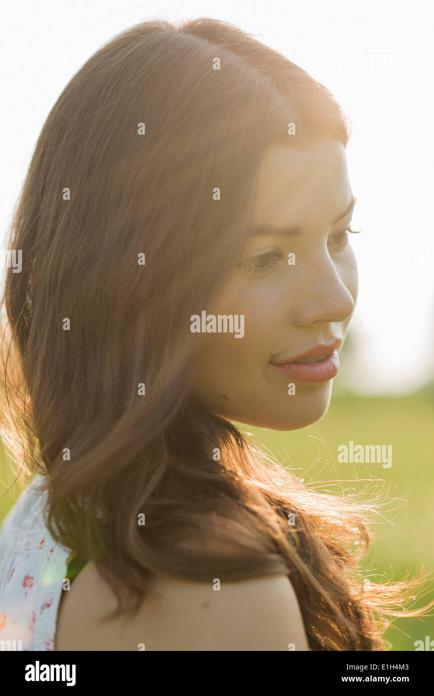 Young brunette woman in sunlight, portrait Stock Photo - Alamy
