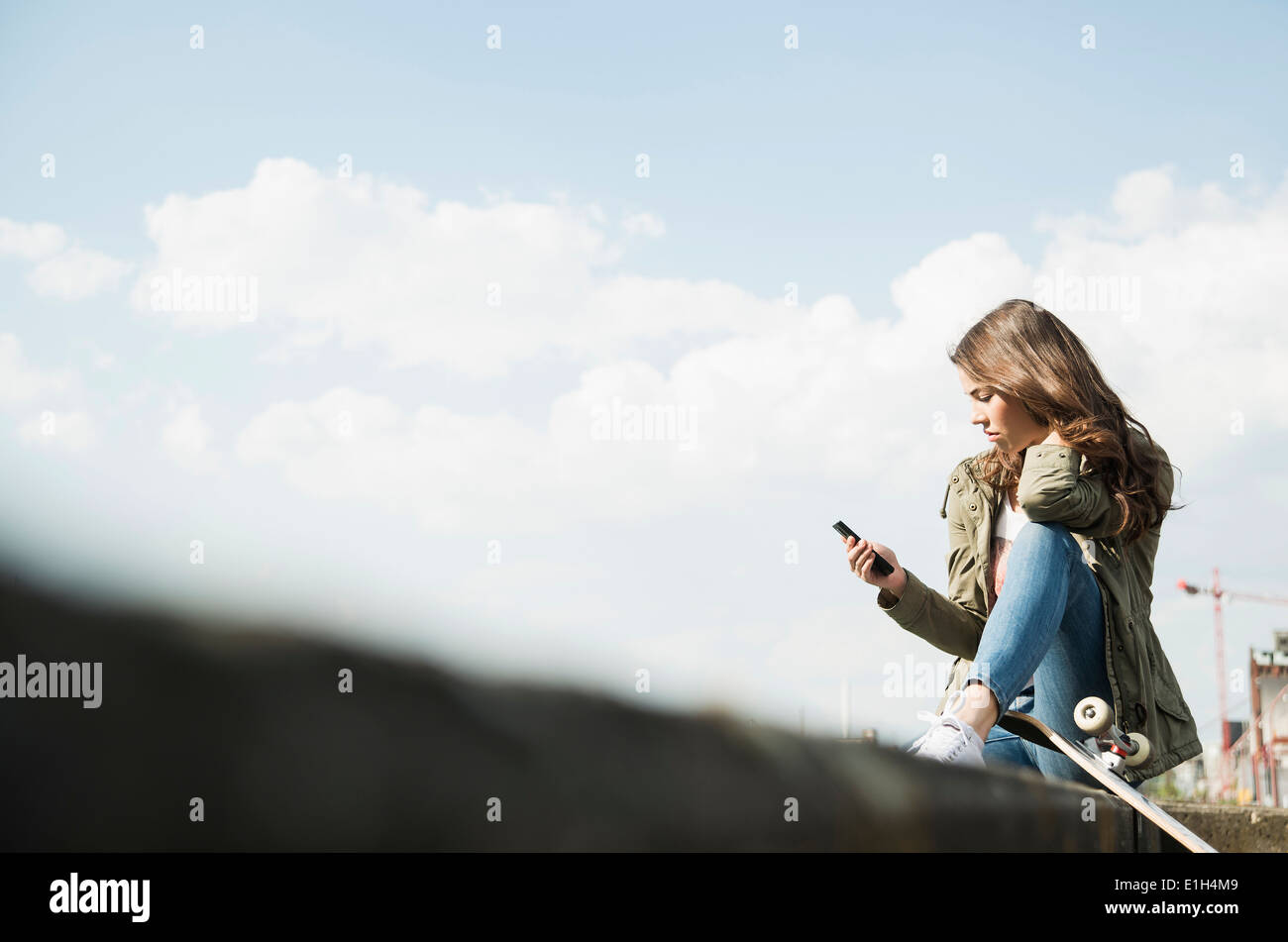 Young woman using cell phone Stock Photo - Alamy