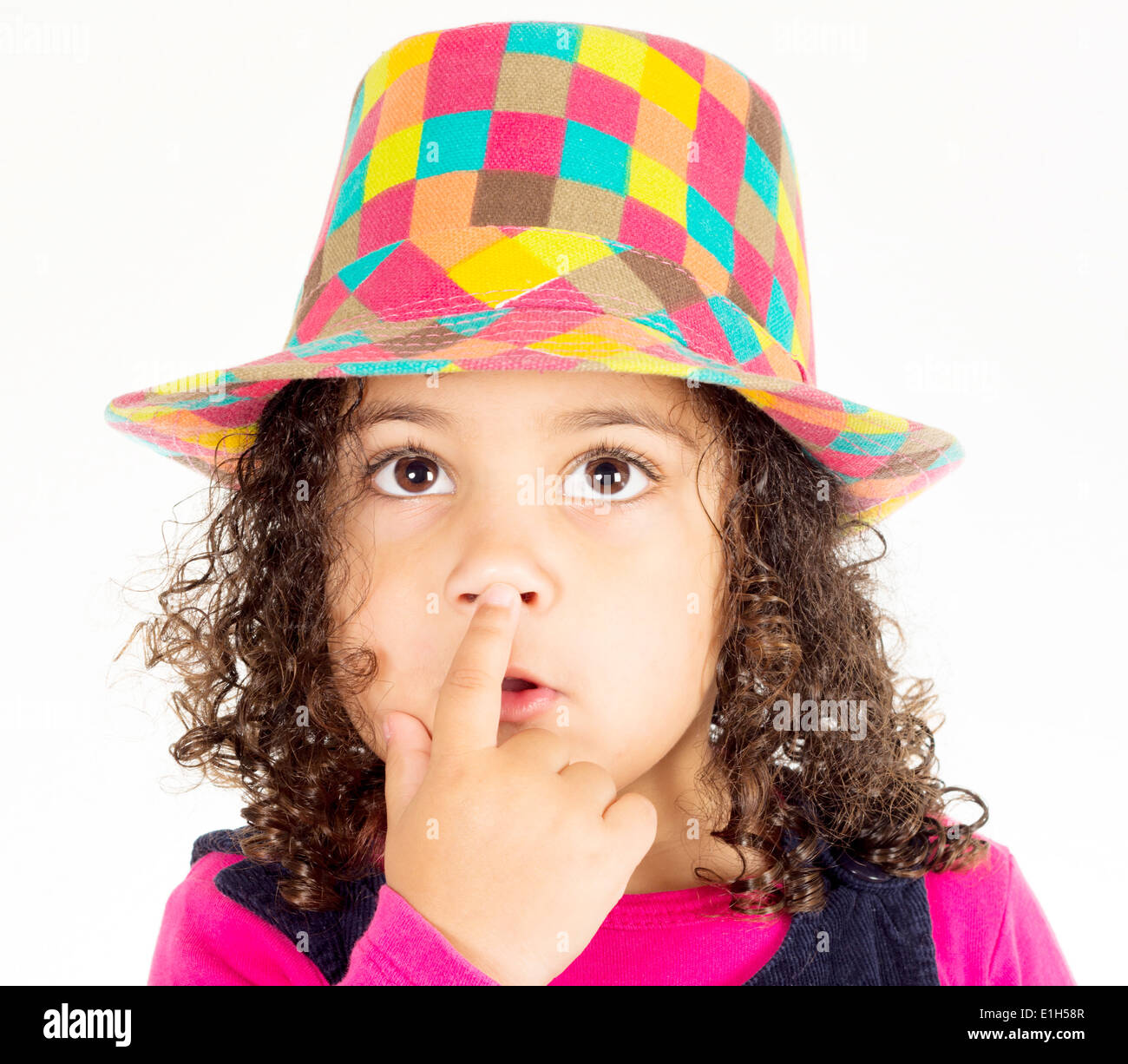 Little girl holding finger on the lips Stock Photo - Alamy