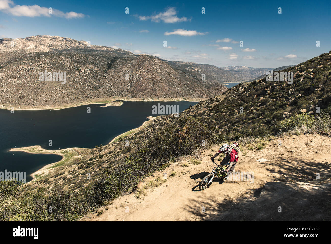 Downhill mountain biker riding downhill Stock Photo - Alamy