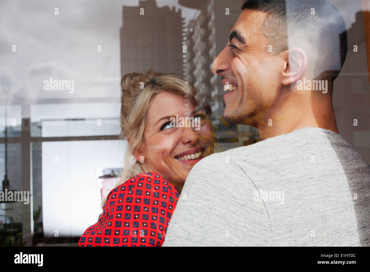 Young couple through window Stock Photo - Alamy
