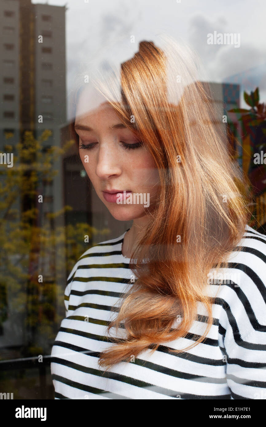 Young women through window hi-res stock photography and images - Alamy