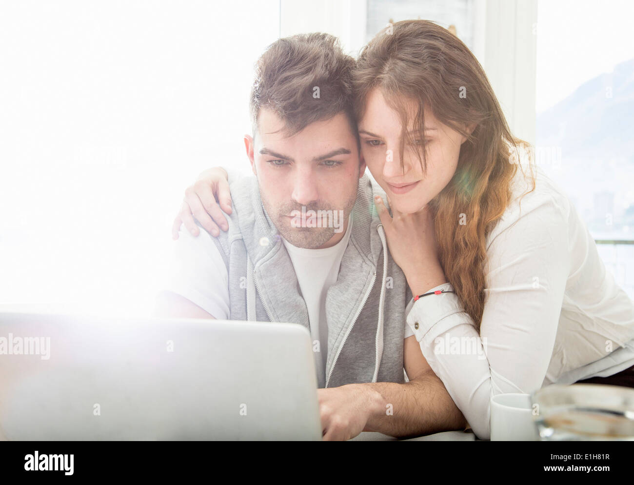 Young couple using laptop Stock Photo - Alamy