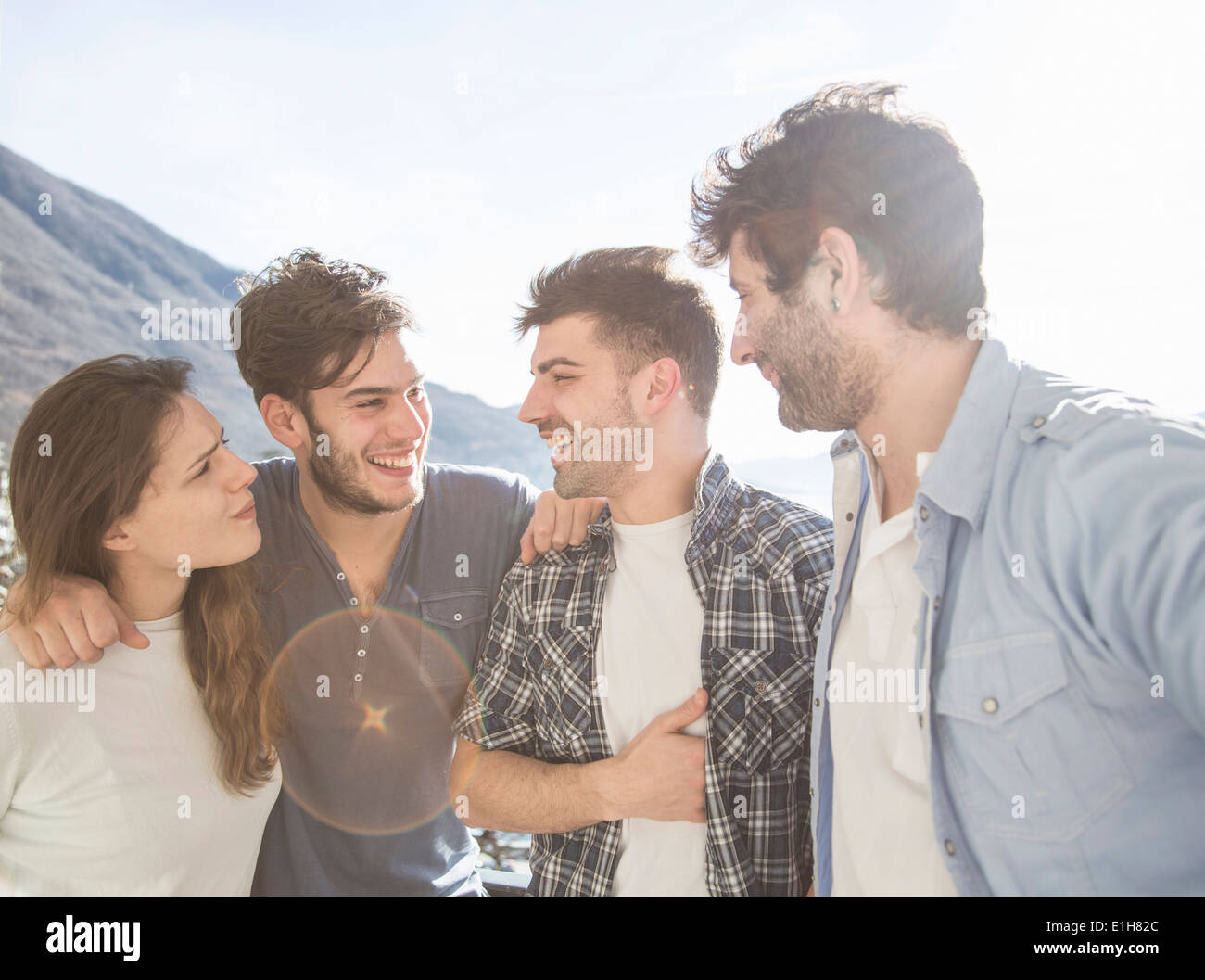 Four friends on mountainside Stock Photo - Alamy