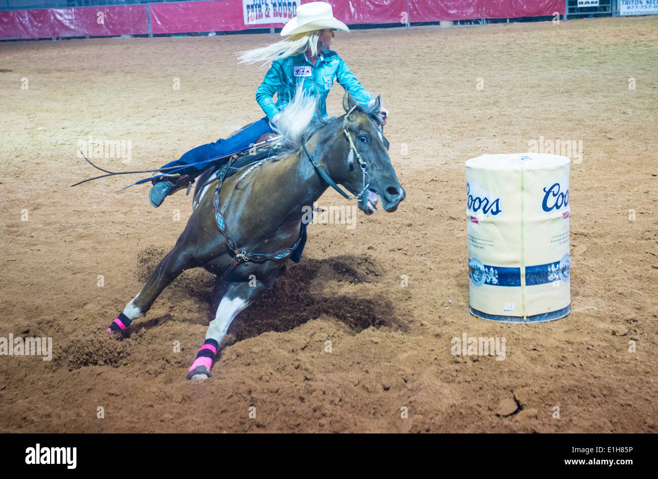 Cowgirl Participating in a Barrel racing competition in the Clark ...