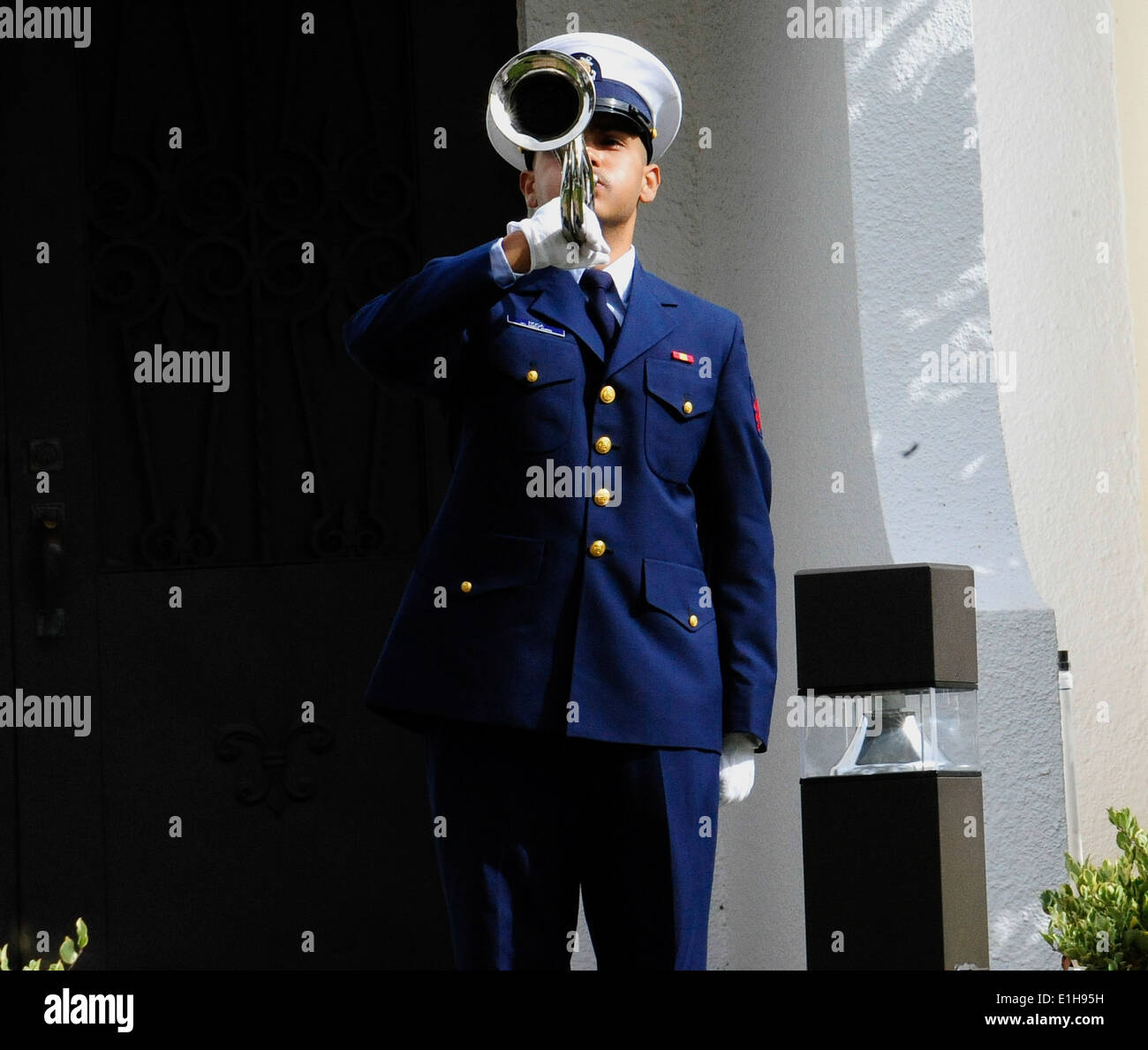 U.S. Coast Guard Fireman Efrain Rosa plays taps during Lt. j.g. Frank ...