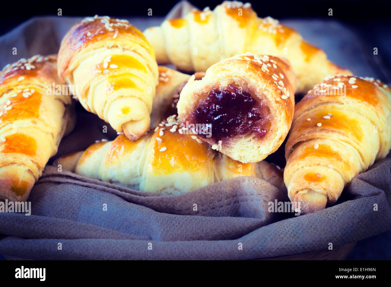 Baked croissants stuffed with sweet fruit jam Stock Photo - Alamy
