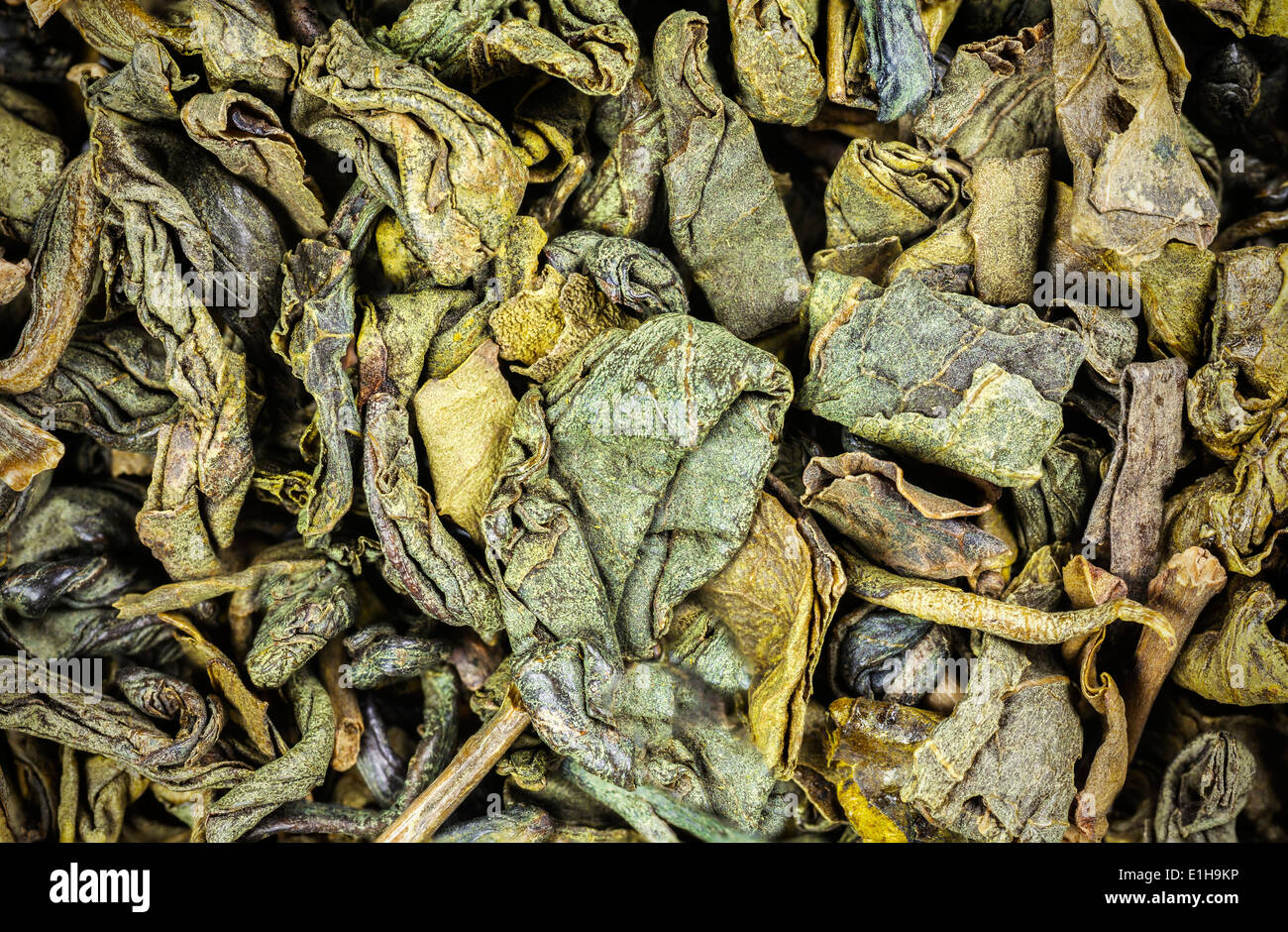 Dried green tea leaves close up background Stock Photo - Alamy