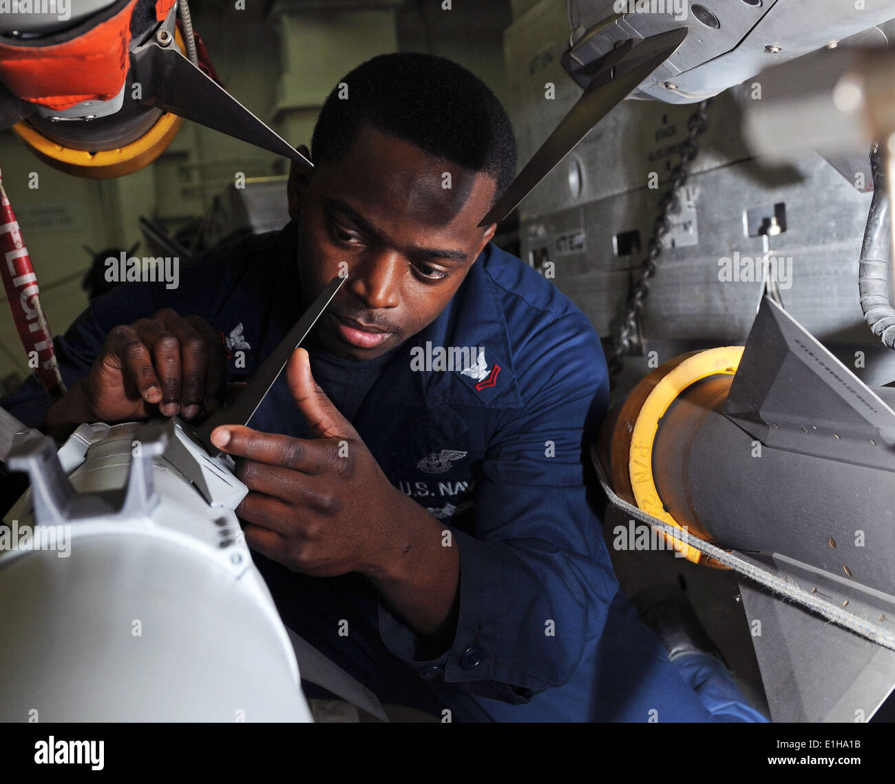 U.S. Navy Aviation Ordnanceman 2nd Class Timothy A. Flowers inspects ...