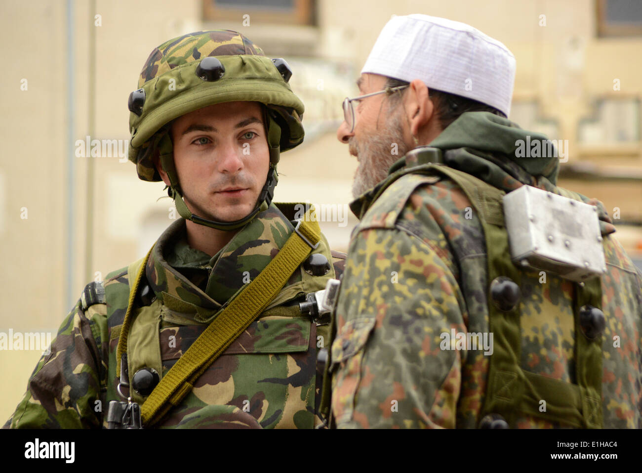 A Romanian soldier, left, talks with a civilian on the battlefield at ...