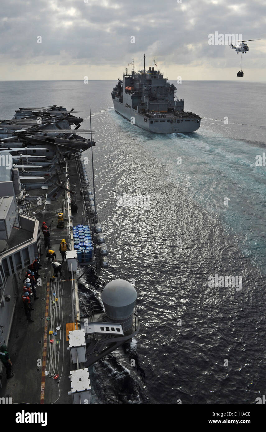 The amphibious assault ship USS Makin Island (LHD 8), left, approaches ...
