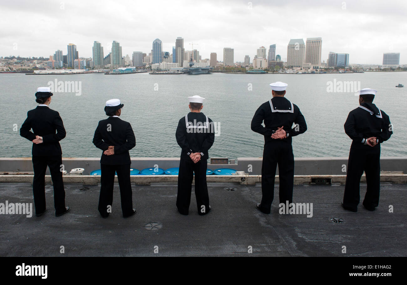 U.S. Sailors man the rails on the flight deck of the aircraft carrier ...